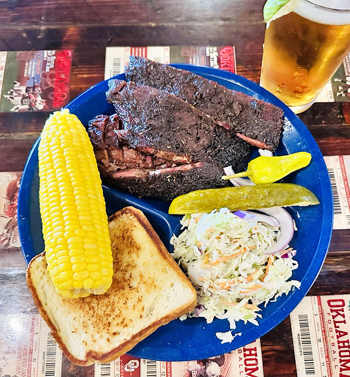 Corn on the cob, Texas toast, and ribs with a smoke ring so perfect it could be used to teach geometry. This is barbecue as an art form.