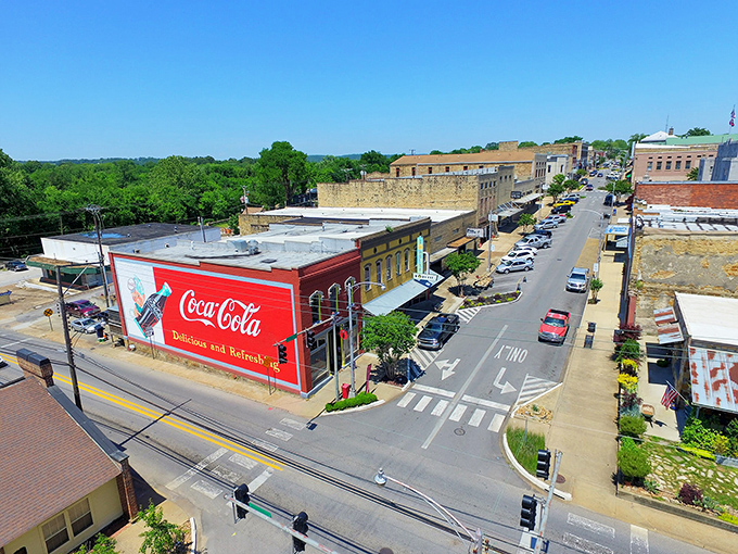 From above, Batesville's classic Main Street reveals itself as the beating heart of a community where vintage Coca-Cola signs still adorn brick buildings.