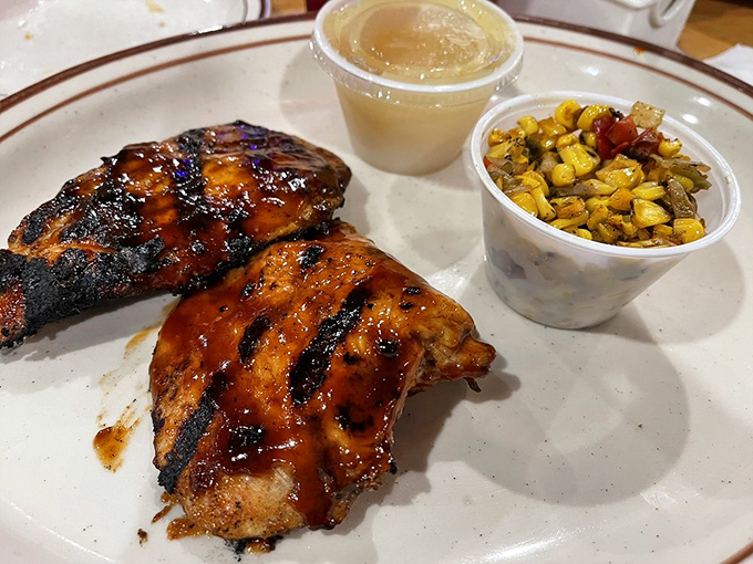 BBQ chicken that wears its grill marks like badges of honor. The corn medley alongside isn't an afterthought&mdash;it's essential for cutting through all that smoky richness.