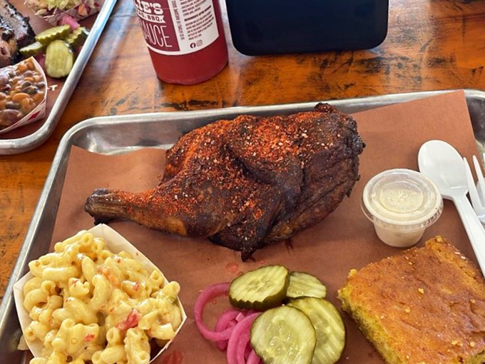 This chicken wears its spice rub like a badge of honor, surrounded by mac and cheese that's practically begging to be devoured.