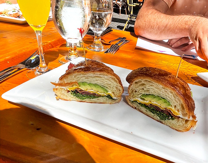 This isn't just a sandwich&mdash;it's architectural genius between two slices of buttery croissant, with layers that deserve their own blueprint. 