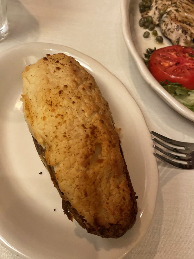 The baked potato—nature's perfect vessel for butter and sour cream. Kreis' version reminds us why this classic never needed reinvention.