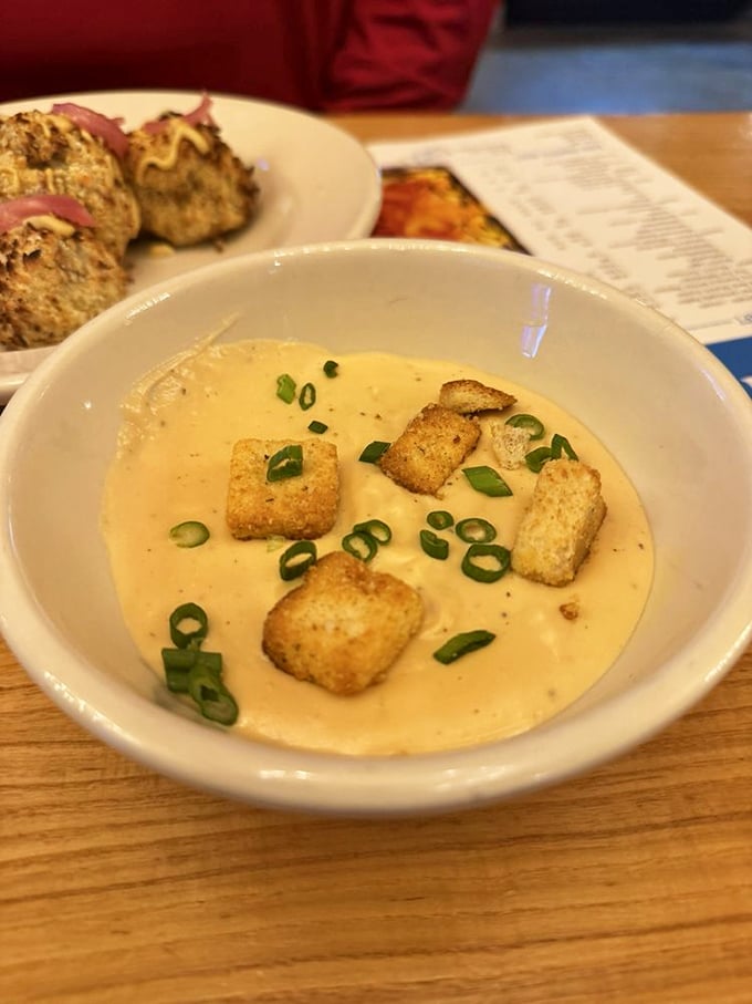 Creamy beer cheese soup topped with crunchy croutons and fresh green onions is the perfect warm comfort food for your afternoon.