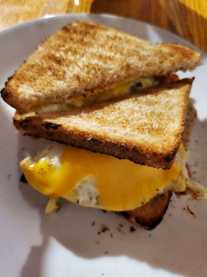 The humble breakfast sandwich elevated to art form. When melted cheese cascades like a yellow waterfall, you know you've hit the breakfast jackpot.