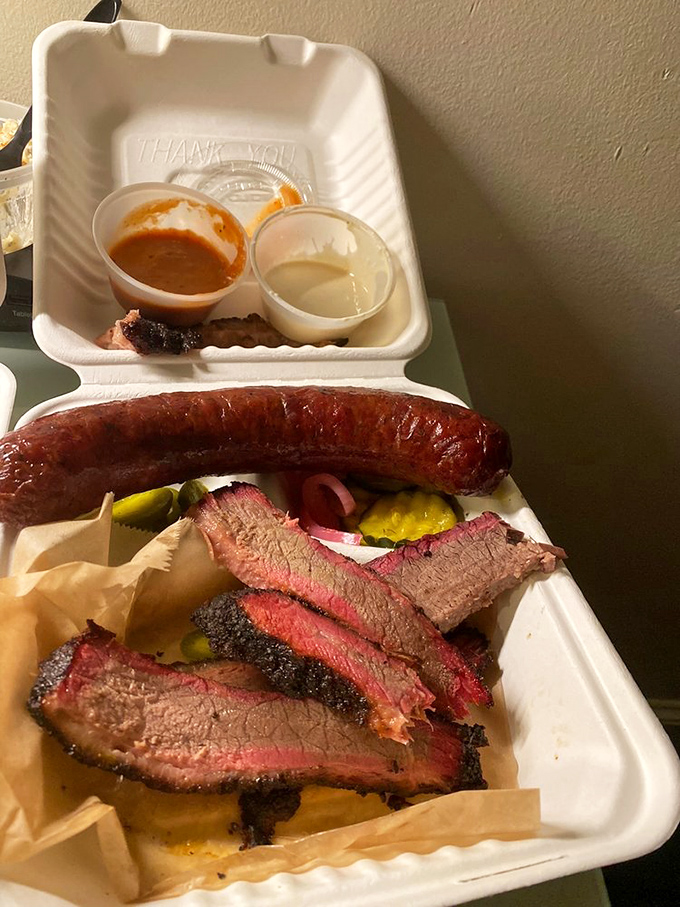 When you can't decide between brisket and sausage, the correct answer is "both." A styrofoam container of pure joy with pickles for good measure.