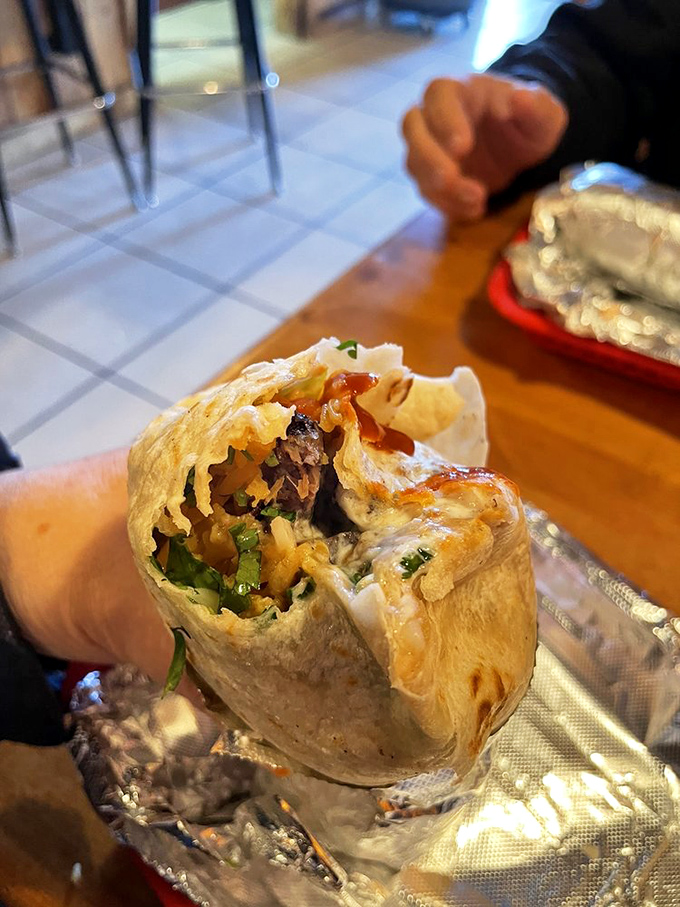 This burrito cross-section reveals the architectural marvel within&mdash;layers of flavor carefully constructed like a delicious edible apartment building.