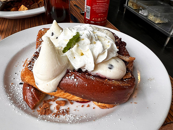 Cannoli French toast topped with enough whipped cream to make your cardiologist wince and your taste buds applaud.