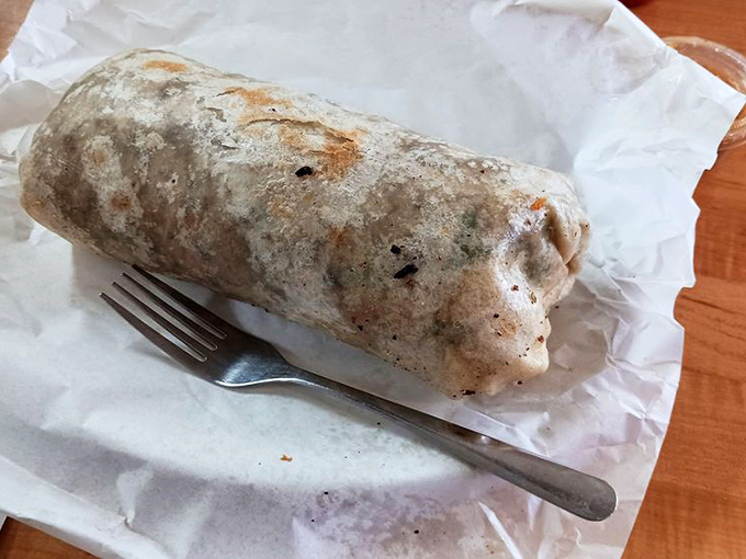 This burrito isn't just a meal, it's a commitment—wrapped tight as a sleeping bag around a campfire of flavors.