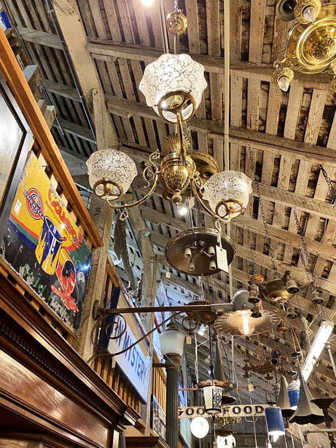 The ceiling is literally dripping with lighting history. Each fixture tells a story of dinners, dances, and decades past.
