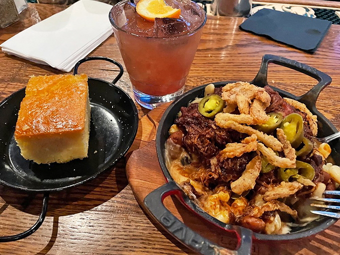 A skillet of comfort that combines pulled meat, crispy toppings, and cornbread&mdash;the barbecue equivalent of a warm hug. 