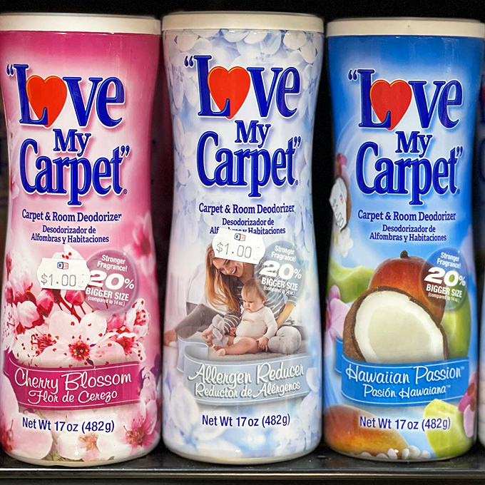 "Love My Carpet" products lined up like soldiers in the war against household odors, each scent promising a different olfactory adventure.