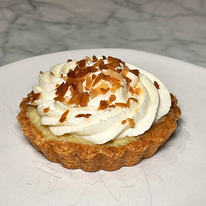 This coconut cream tart isn't messing around. Those toasted coconut flakes on top are like the confetti at your personal victory parade. 