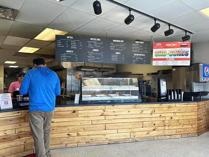 The minimalist menu board and wooden counter say, "We're serious about pretzels, not fancy d&eacute;cor." Priorities, perfectly aligned.