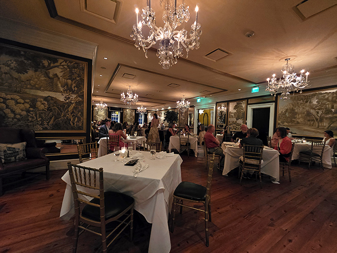 Dinner guests bask in chandelier light against historic walls&mdash;the kind of ambiance you can't manufacture with an Instagram filter.