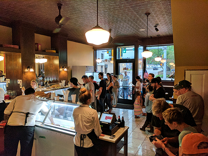 The universal queue of ice cream anticipation &ndash; where strangers become comrades united in the noble pursuit of dairy perfection.