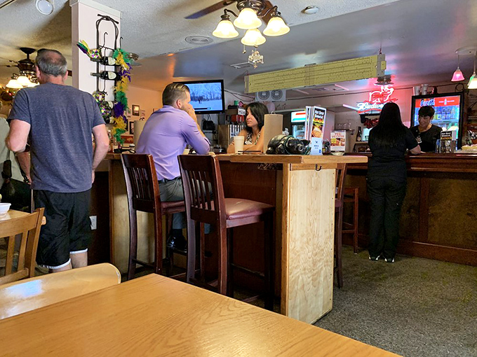 The bar area: where strangers become friends over shared appreciation of smoked meats. Some of the best barbecue conversations happen while waiting for your order.