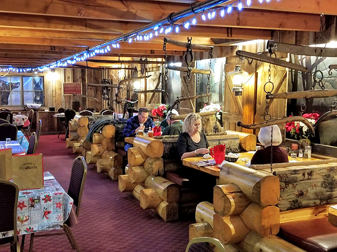 Log cabin booths create private dining nooks where the only appropriate conversation topic is how good your steak tastes.
