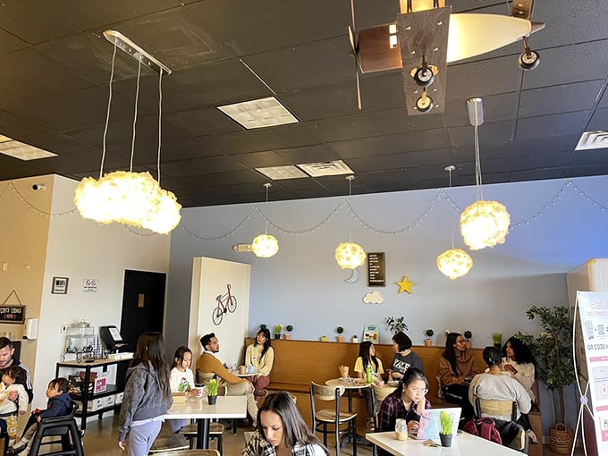 Weekend warriors gather under whimsical light fixtures, plotting their day over plates that demand to be photographed first.