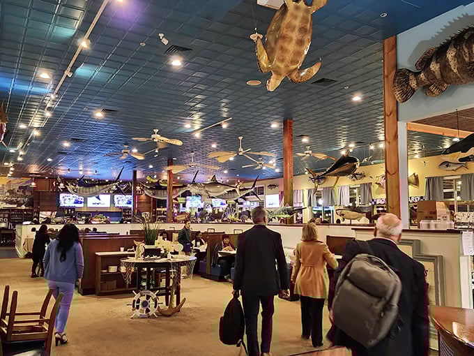 Beneath a menagerie of marine life, diners navigate their way through a sea of culinary treasures in Big Fish's bustling main dining room.