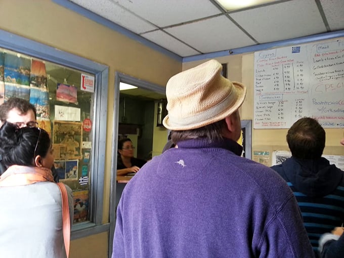 The line forms with the patience of pilgrims. That fedora isn't just a fashion statement&mdash;it's a veteran Nick's customer who knows that greatness requires a short wait.