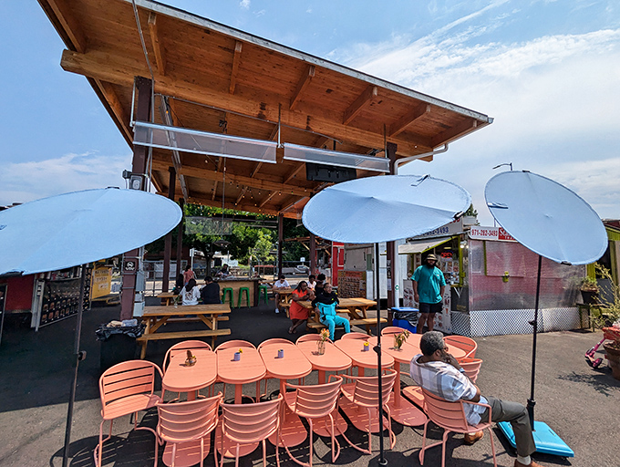 Blue umbrellas provide shade while diners engage in the universal ritual of the "food coma nod"&mdash;that slow, satisfied head bob after a transcendent bite.