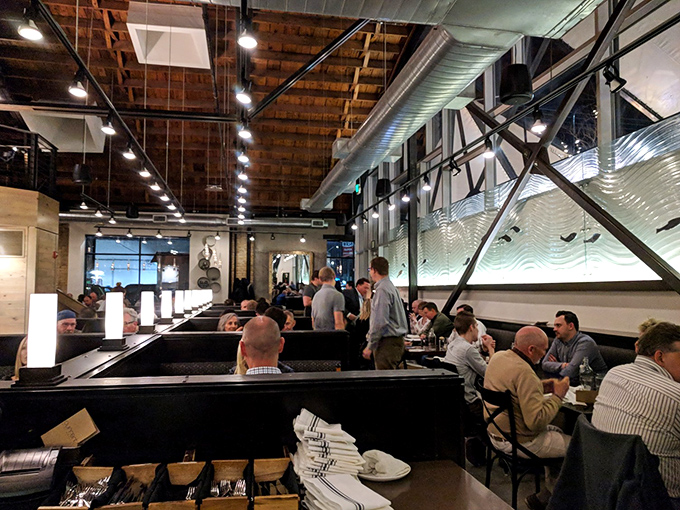 The dining room hums with the energy of people having religious experiences with seafood. That wave-inspired wall art isn't just decoration&mdash;it's foreshadowing.