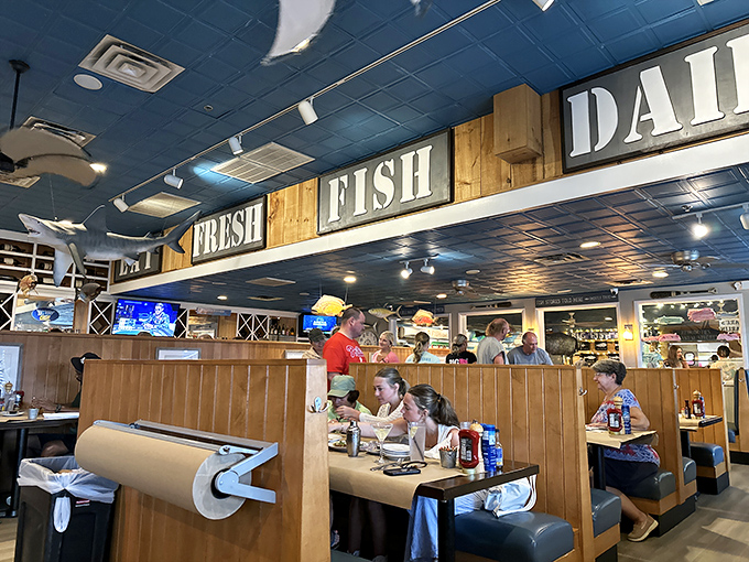 The bustling bar area where locals and tourists unite in the universal language of "pass the tartar sauce."