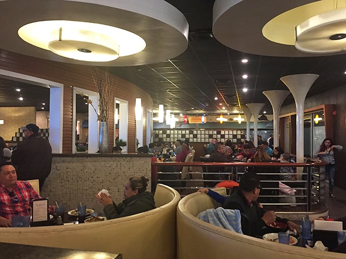 Diners settle into comfortable curved booths, creating a symphony of satisfied murmurs beneath modern lighting. Everyone's on a personal food quest here.