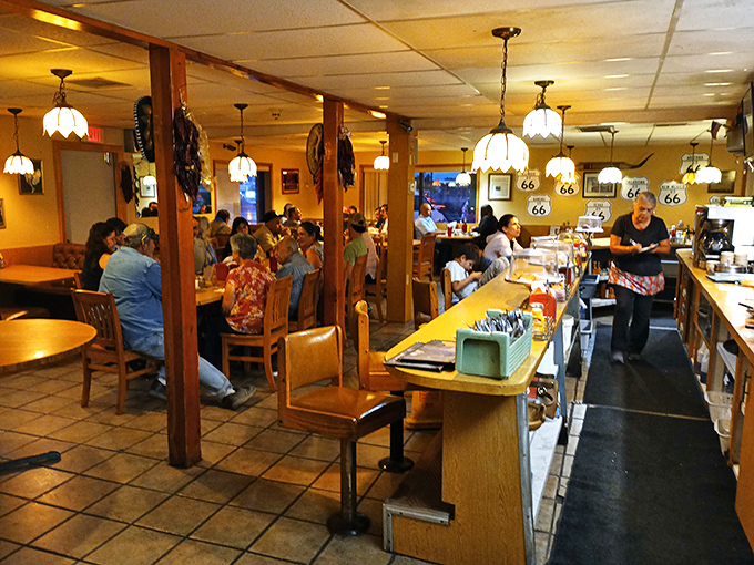 Where locals gather to solve the world's problems one coffee refill at a time, under the warm glow of those signature tulip-shaped pendant lights.