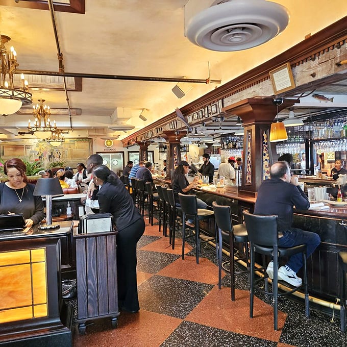The bar area hums with conversation and clinking glasses. A perfect perch for solo diners or those waiting for a table.