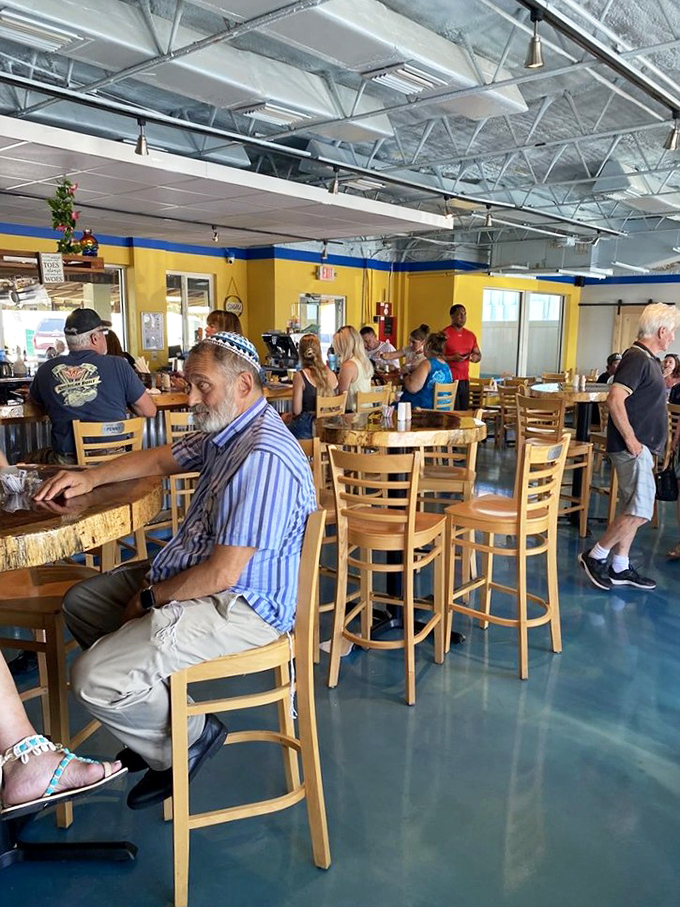 A lively crowd of breakfast devotees gathering at the altar of morning meals &ndash; some wearing hats indoors because that's the Florida breakfast club dress code.