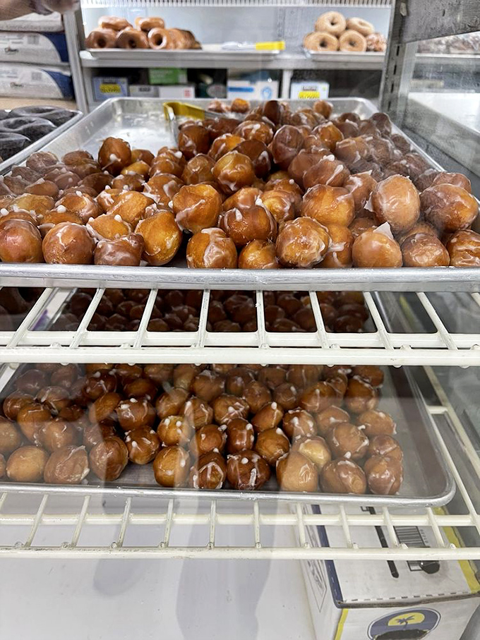 Trays of golden-brown donut holes glistening with glaze &ndash; like edible amber preserving the sweetness of simpler times.
