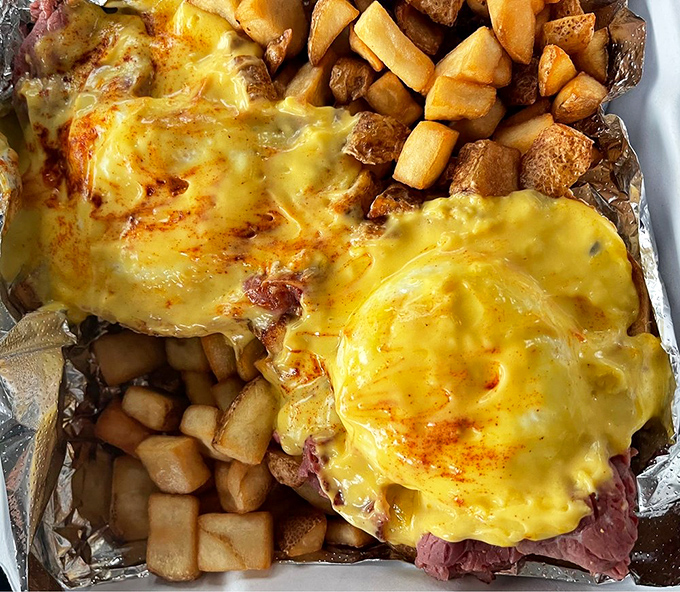 A sandwich so substantial it requires both hands, engineering skills, and possibly a recovery nap. Worth every penny and every minute of that food coma.