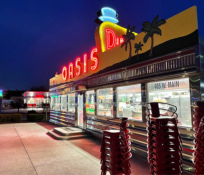 At night, the neon glow of Oasis Diner cuts through darkness like a beacon for hungry travelers and locals seeking comfort food salvation.