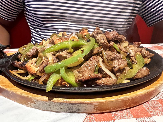 Sizzling fajitas that announce their arrival before you see them. Tender meat and perfectly charred peppers performing a culinary duet on a cast-iron stage.