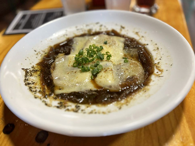 French onion soup with an identity crisis worth embracing. That melted cheese cap is like a warm, gooey security blanket for your taste buds.