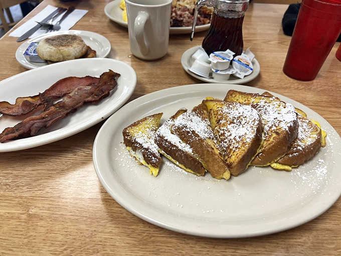 French toast dusted with powdered sugar alongside crispy bacon&mdash;proof that the sweet and savory debate was settled long ago with "both."
