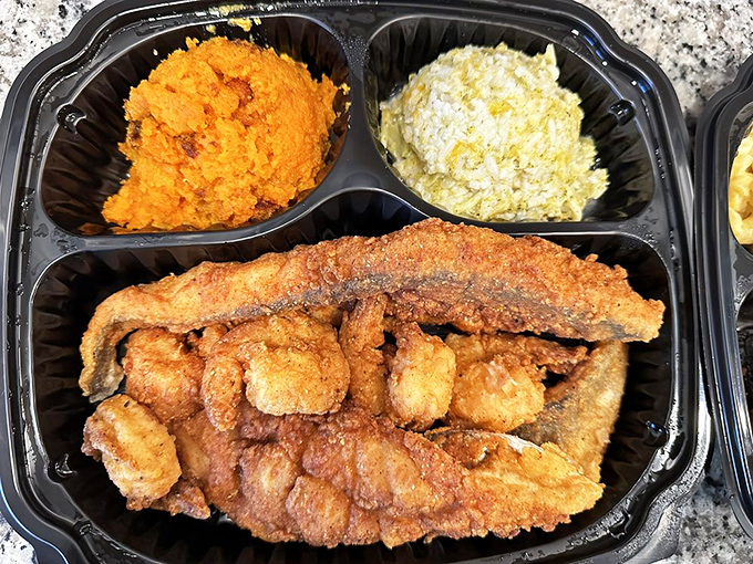 Orange-hued sweet potatoes and vibrant collards frame the star of the show—fried fish that would make any Southern cook proud.