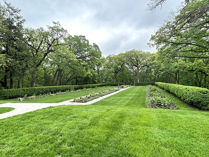 The manicured gardens offer geometric precision against Iowa's natural landscape&mdash;formal hedgerows creating outdoor rooms where nature obediently follows human design.