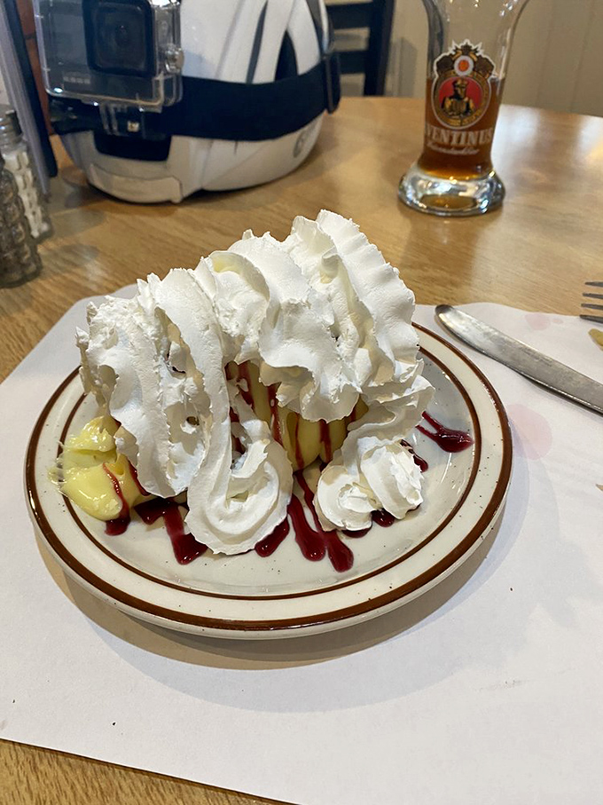 Whipped cream mountains atop what appears to be cheesecake&mdash;a dessert so excessive it requires both a fork and a climbing permit.