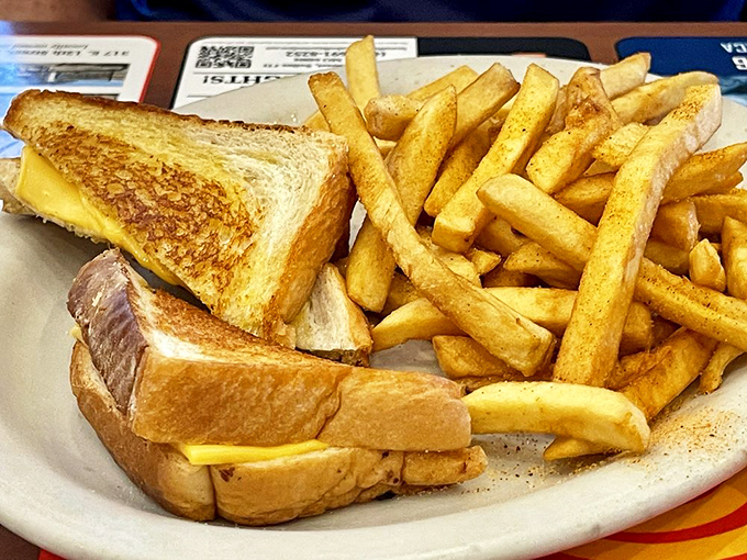 The humble grilled cheese achieves sandwich perfection alongside fries that strike the ideal balance between crispy exterior and fluffy interior.