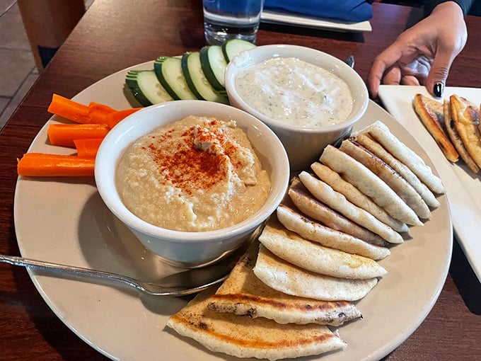 Hummus and tzatziki with warm pita triangles &ndash; the kind of appetizer that makes you wonder if you really need a main course after all.