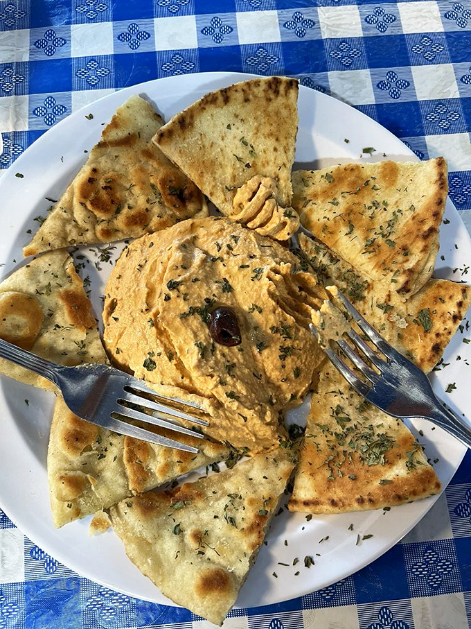 Hummus surrounded by pita triangles&mdash;a delicious game of edible connect-the-dots where everybody wins, especially your taste buds.