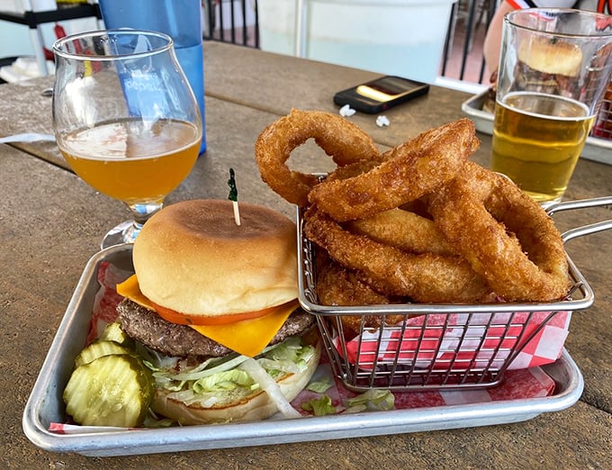 A burger and onion rings that have achieved perfect harmony. Like a great marriage, each makes the other better, and that pickle is the witness.