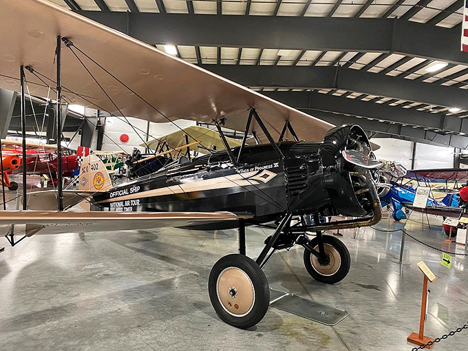 The vibrant red Laird biplane epitomizes the barnstorming era, when daredevil pilots would travel town-to-town thrilling crowds with aerial acrobatics.