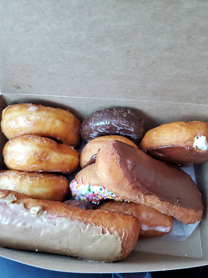 The holy trinity of donut perfection: glazed rings, twisted glory, and a maple long john that deserves its own fan club.