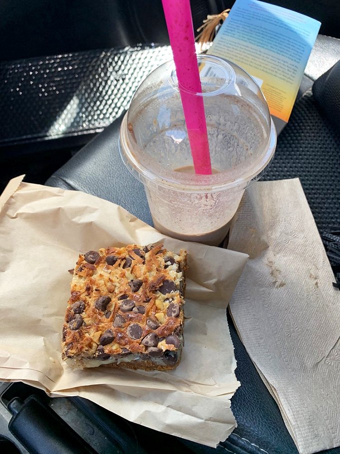 Road trip sustenance that elevates the entire journey. This magic bar and iced coffee combo turns your car into a rolling caf&eacute; with mountain views.