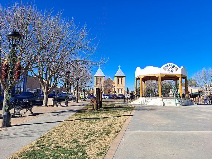 Winter reveals the plaza's elegant bones, where bare trees frame the basilica and the gazebo awaits the return of musicians and dancers.