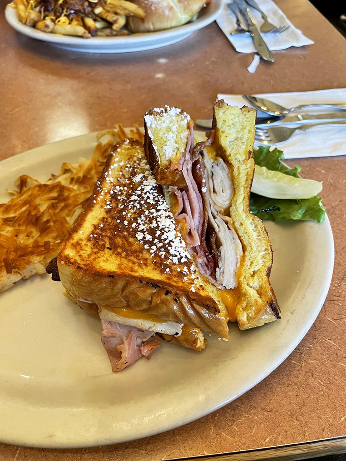 The Monte Cristo: where breakfast and lunch collide in a powdered-sugar dusted embrace. Half sandwich, half French toast, complete magic.