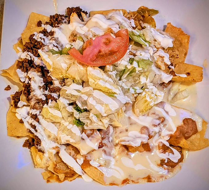 Nachos that laugh in the face of moderation, where every chip has struck gold in the form of seasoned beef, cheese, and fresh toppings.
